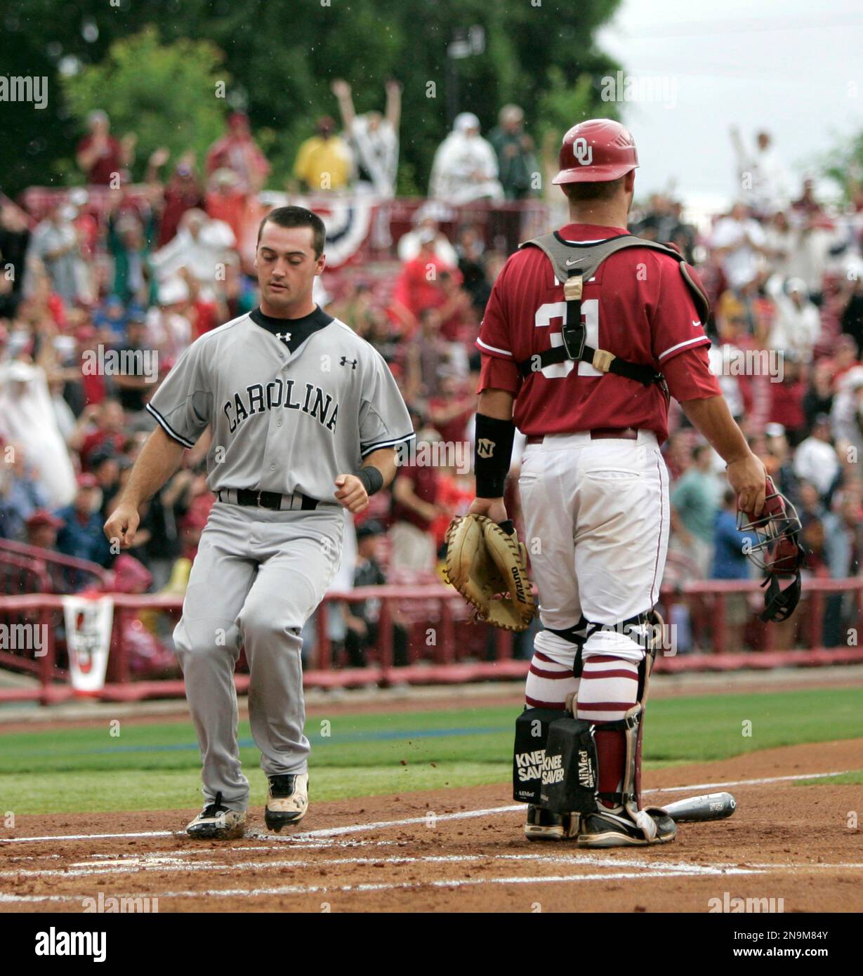 South Carolina's TJ Costen, left, scores after Oklahoma's Garrett Carey ...