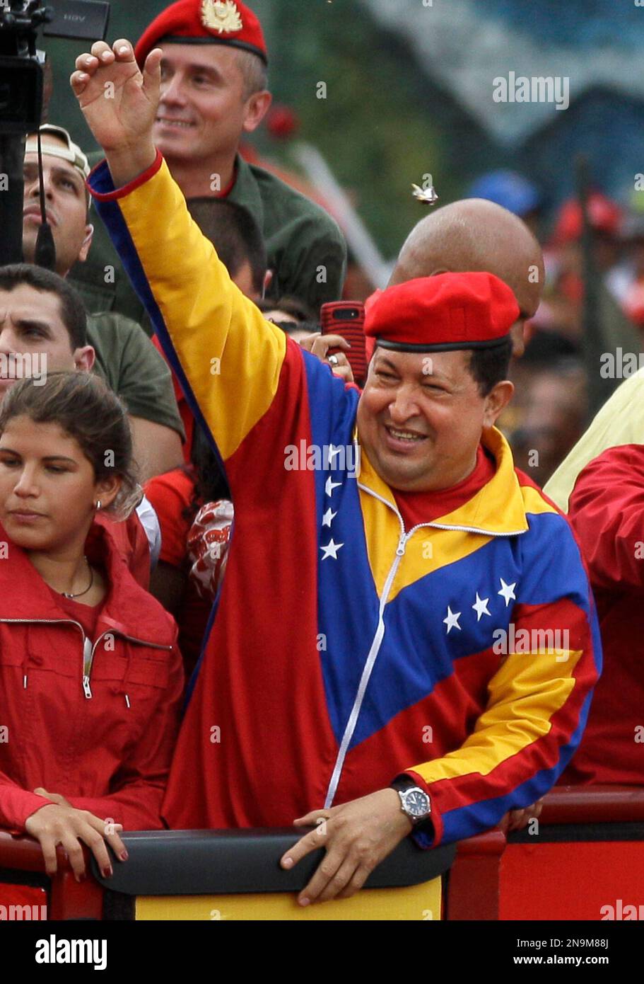 Venezuela's President Hugo Chavez, right, waves to the crowd while ...