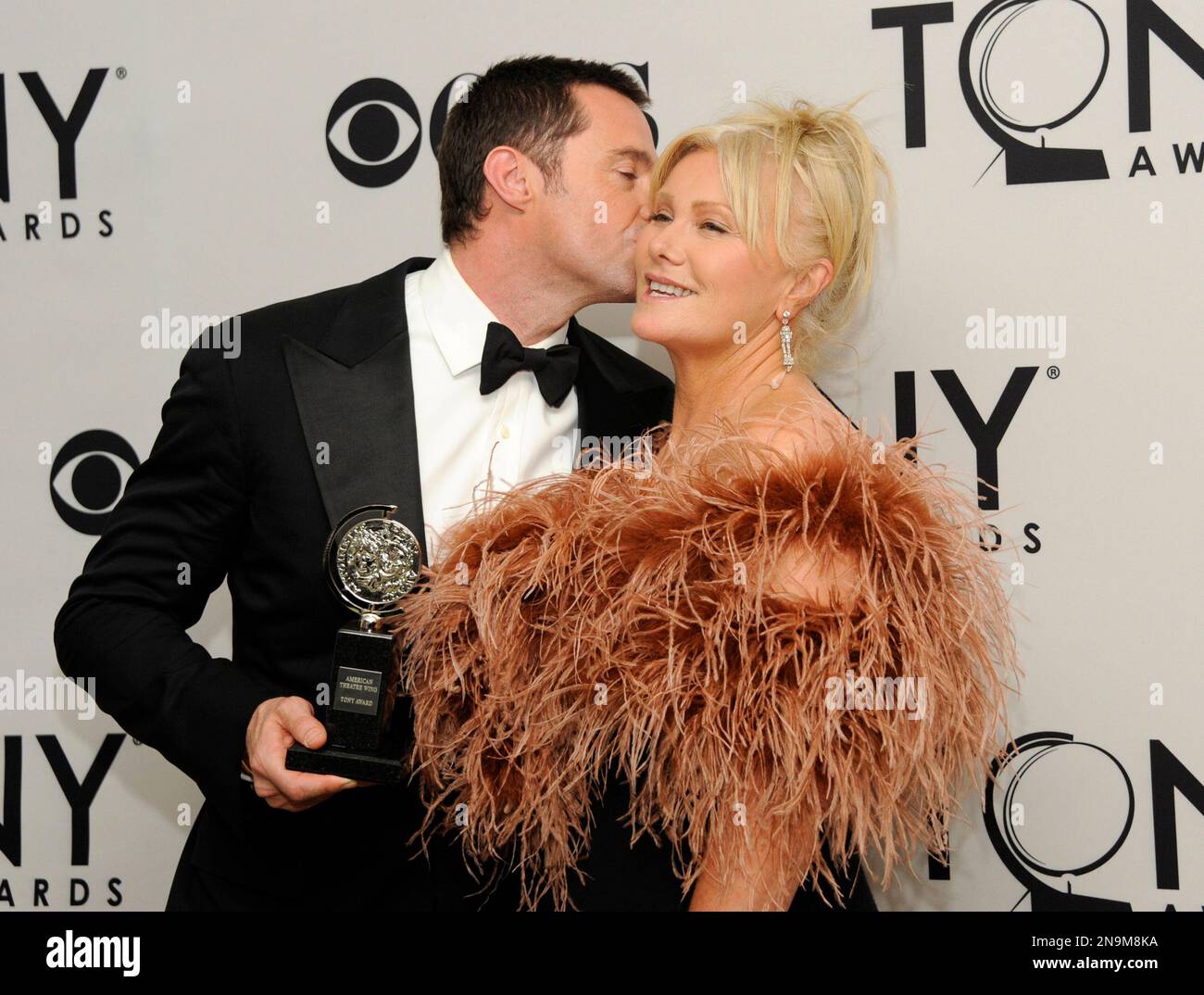 Actor Hugh Jackman kisses wife Deborra-Lee Furness in the press room at ...