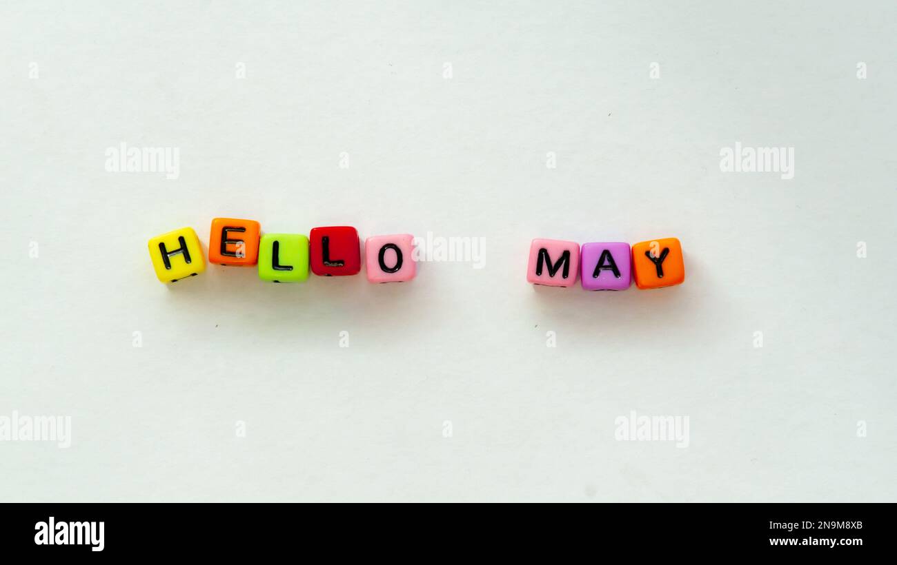 May coming and changing April. Spring concept. Colorful letter beads on ...