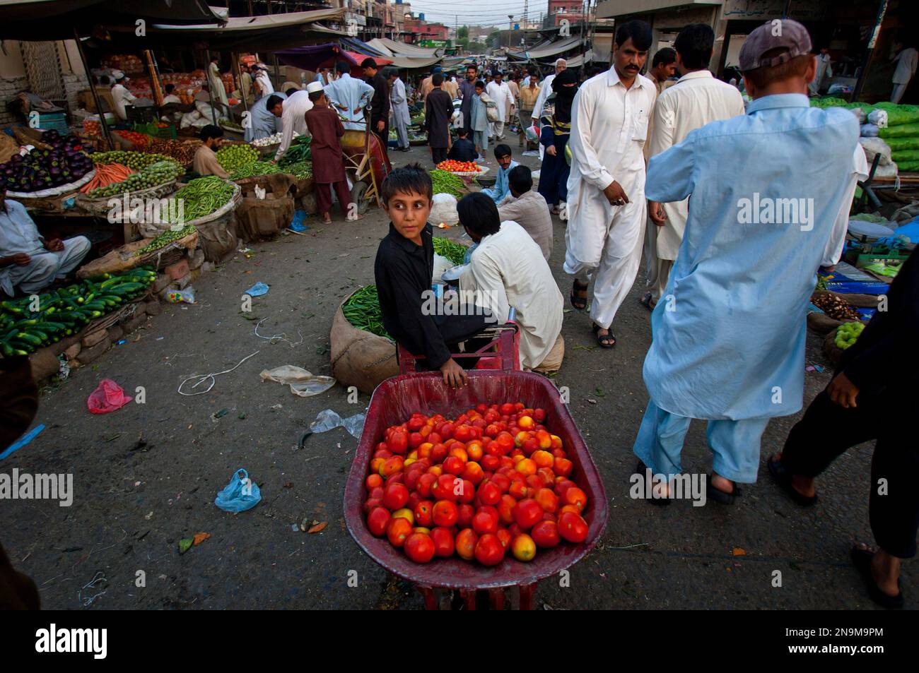 A Pakistani boy Javed Khan, 10, who earns 385 rupees ($4.08) in an ...