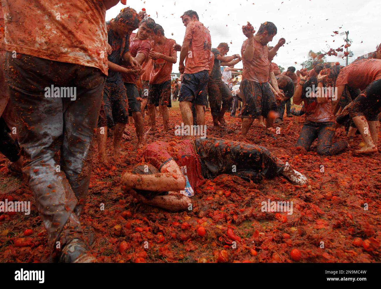 People participate in the sixth annual tomato fight festival called ...