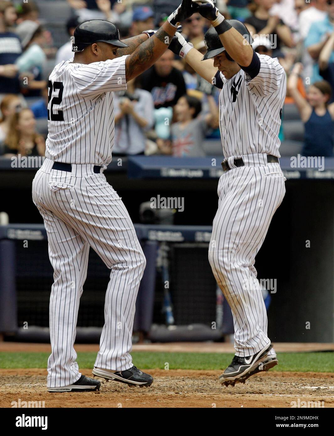 New York Yankees' Andruw Jones, left, celebrates with teammate Russell ...