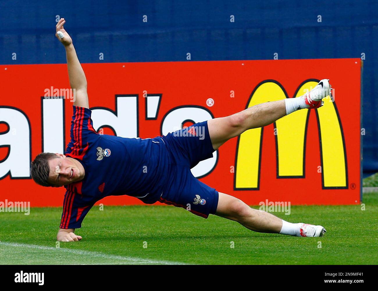 Russia's Andrei Arshavin stretches during a training session at the ...