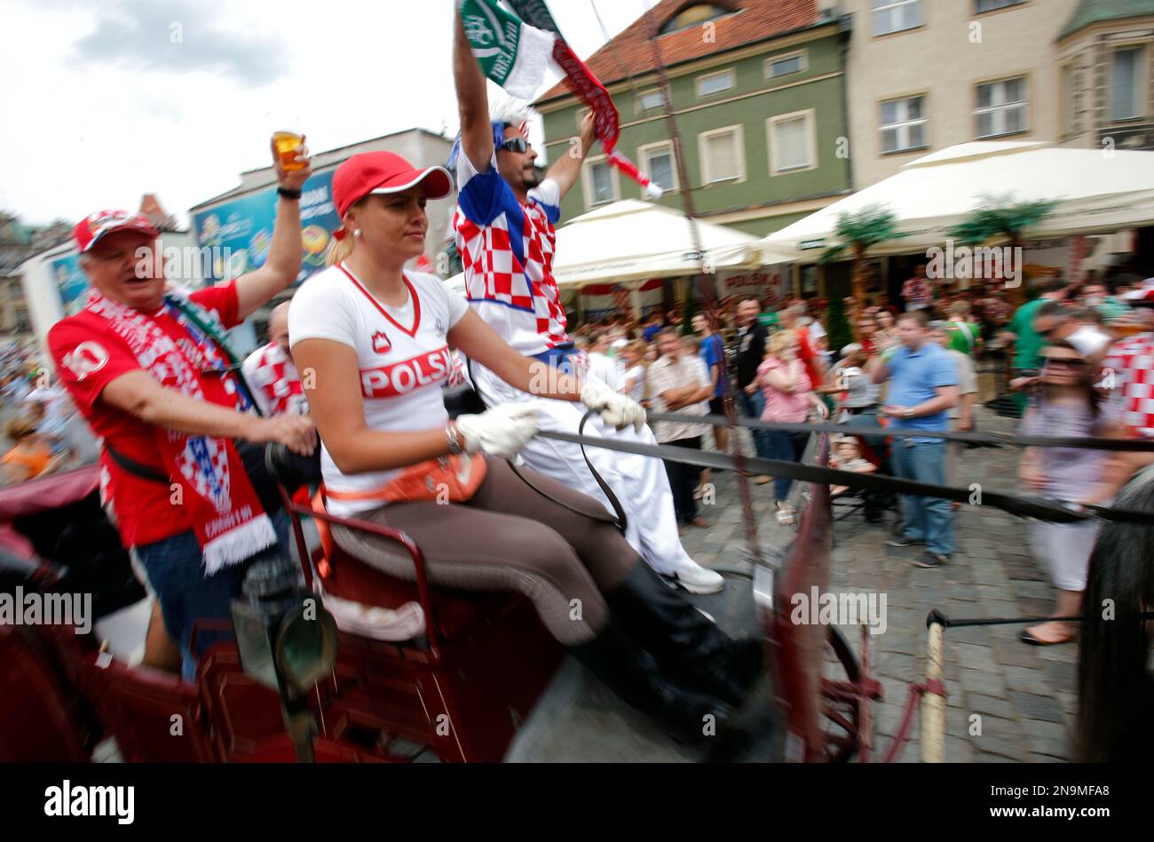 Croatian soccer fans move through the fan zone on a horse-drawn ...