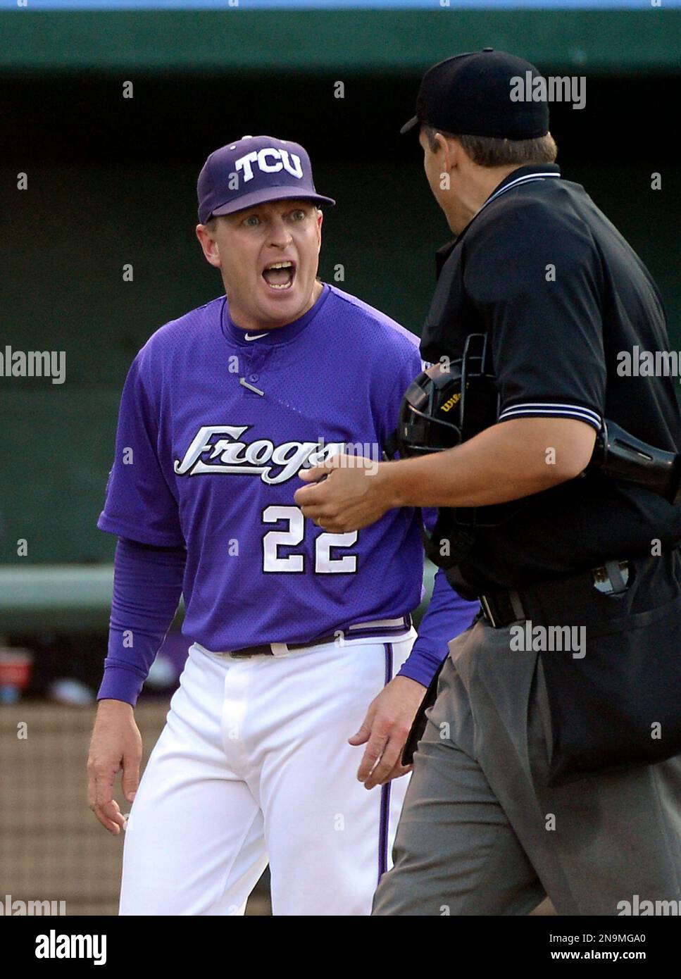 TCU head coach Jim Schlossnagle, left, argues a play at third base with ...