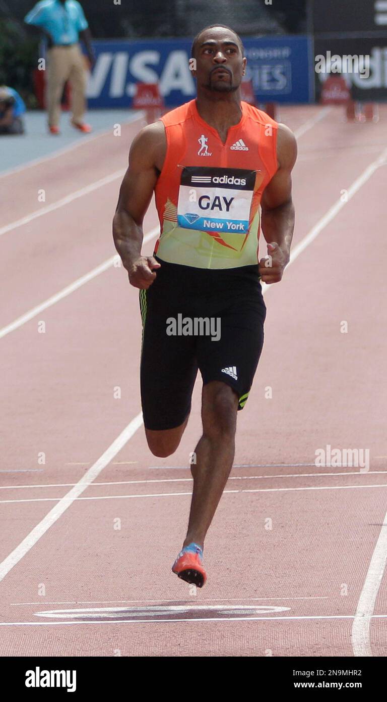 Tyson Gay crosses the finish line ahead of the pack during the 100 ...