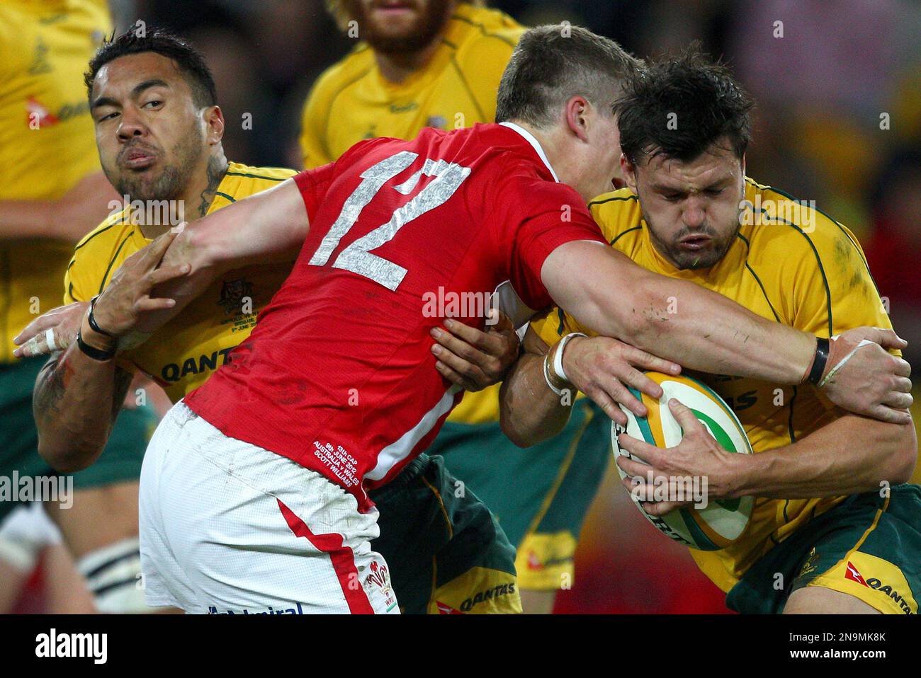 Wales' Scott Williams, center, wraps up Australia's Adam Ashley-Cooper ...
