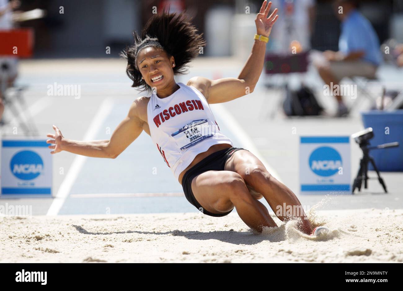 Wisconsin's Jessica Flax lands in the pit during the long jump event in ...