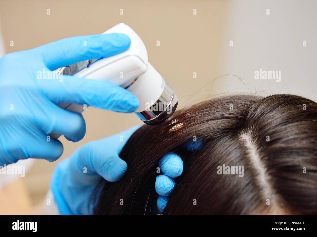 A close-up of a cosmetologist-trichologist diagnoses the condition of ...