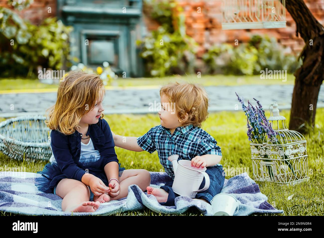 Kids at picnic. Happy child in park. Sister feeding baby boy. Girl ...