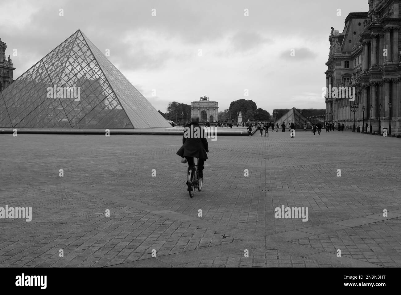 A grayscale shot of the exterior of the Louvre Museum in Paris, France ...