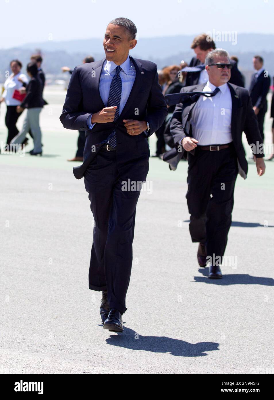 President Barack Obama jogs on the tarmac upon his arrival at San ...