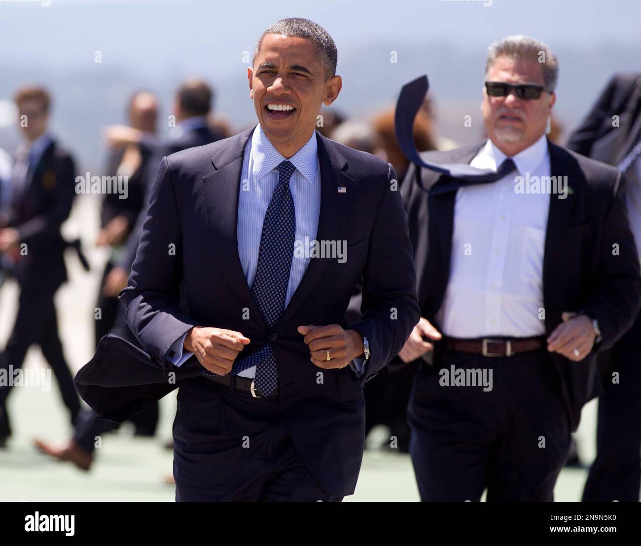 President Barack Obama jogs on the tarmac as he arrives at San ...