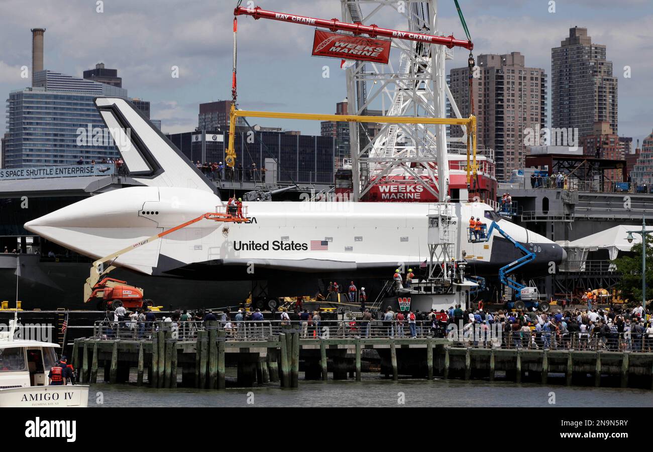 The space shuttle Enterprise is prepared to be lifted to its new home ...