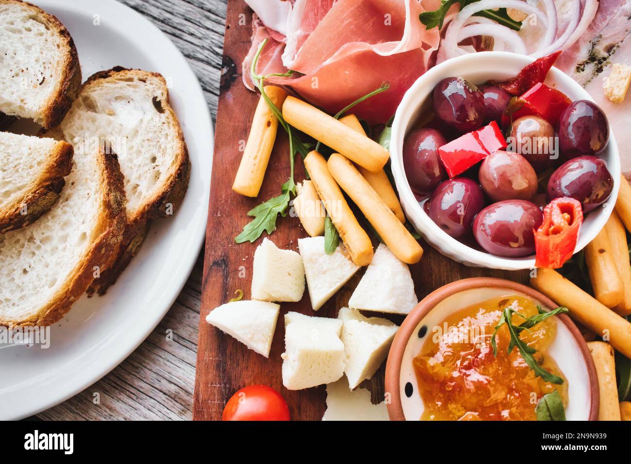 A Mediterranean deli platter with a selection of cheeses and cured ...
