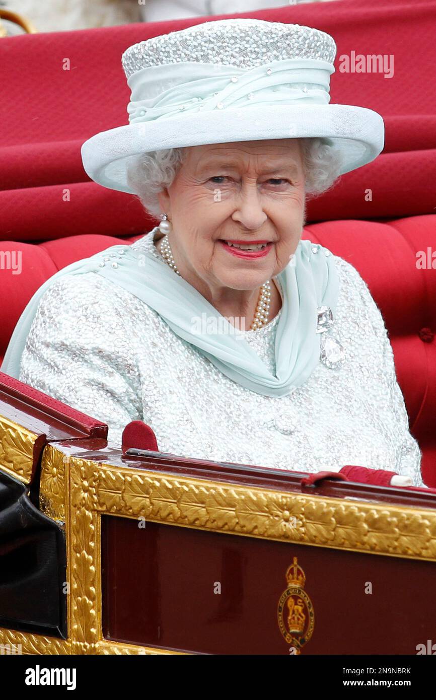 Britain's Queen Elizabeth II travels in a horse drawn carriage ...