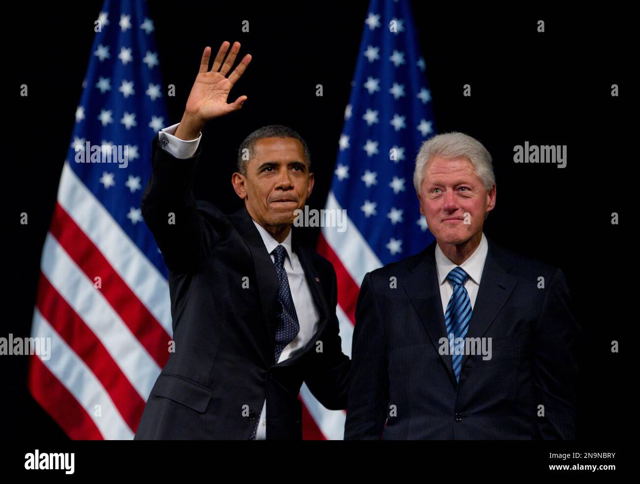 Former President Bill Clinton and President Barack Obama look to the ...