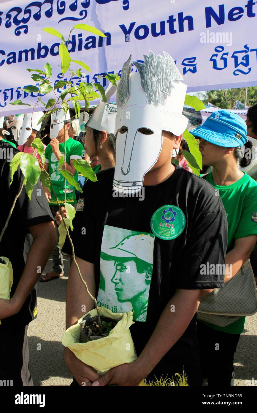 A Cambodian environmental activist wears a mask symbolizing a wild ...