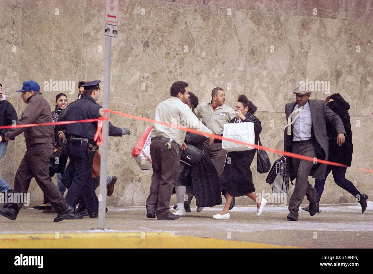 Passersby and workers rush from the explosion scene at the World Trade ...