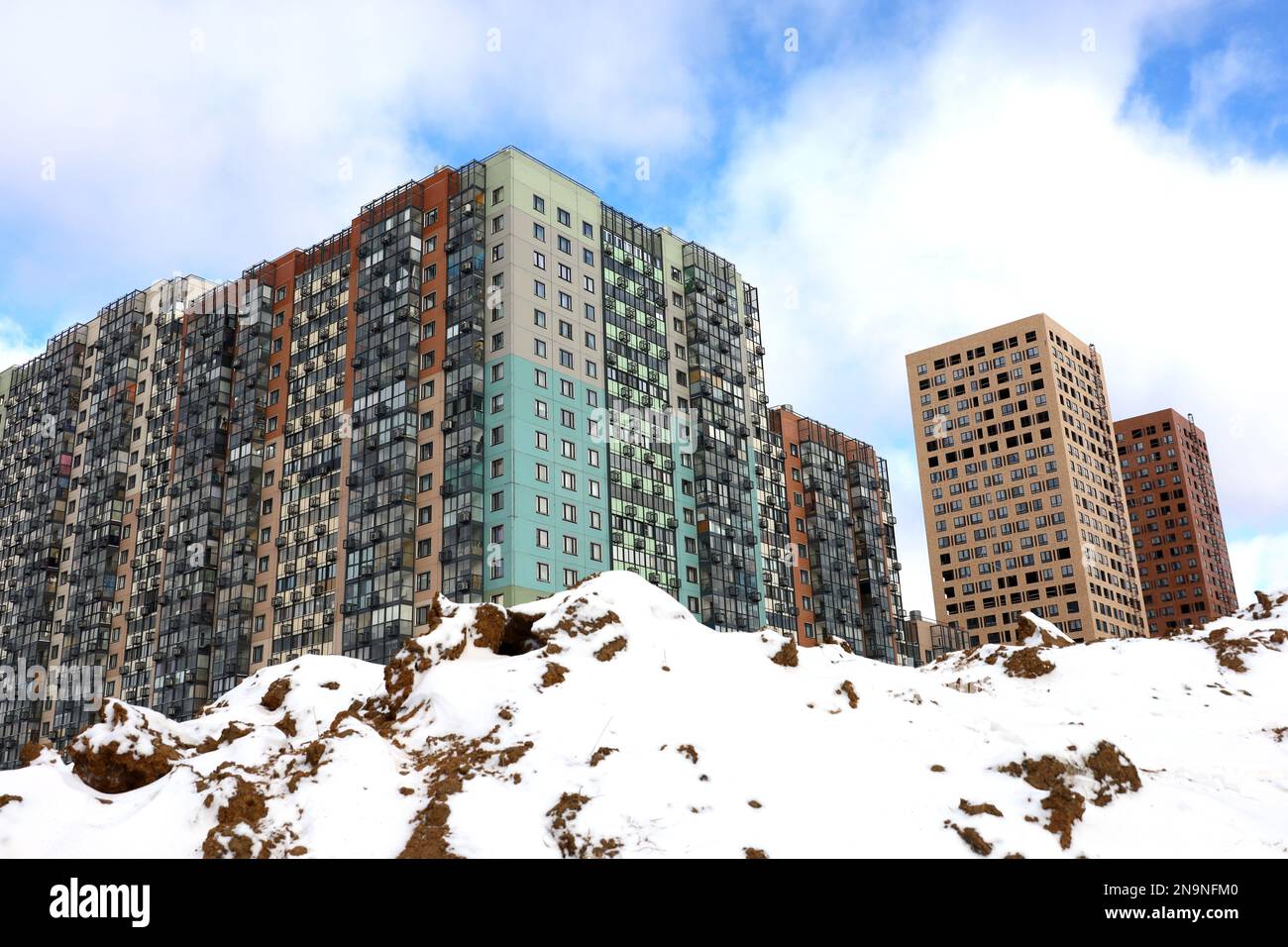 Residential district in winter city, view from snow covered pile of ...