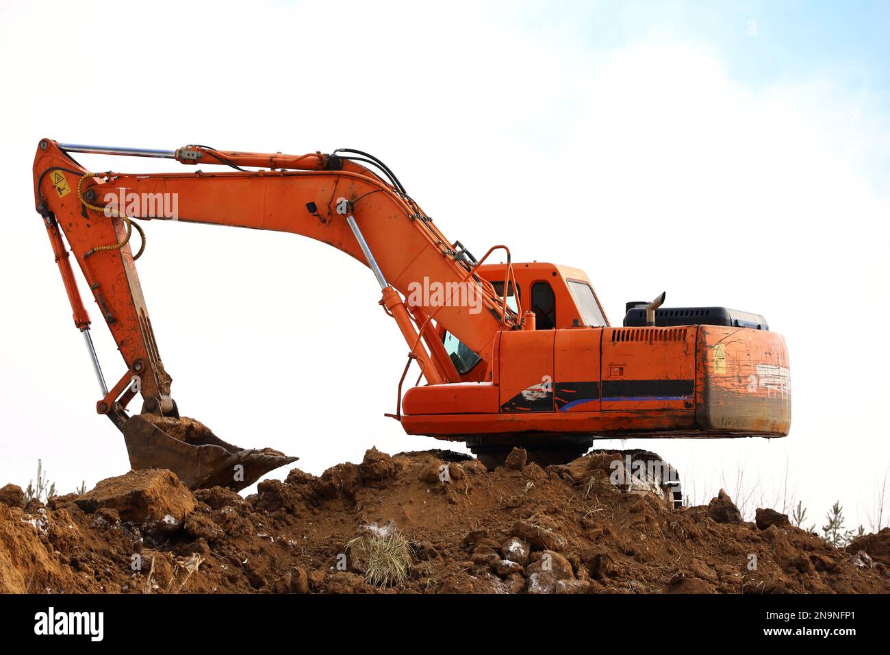 Crawler excavator scoops the earth with a bucket. Earthmoving works ...