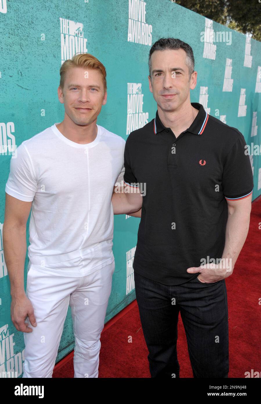 Dan Savage, right, and Terry Miller arrive at the 2012 MTV Movie Awards ...