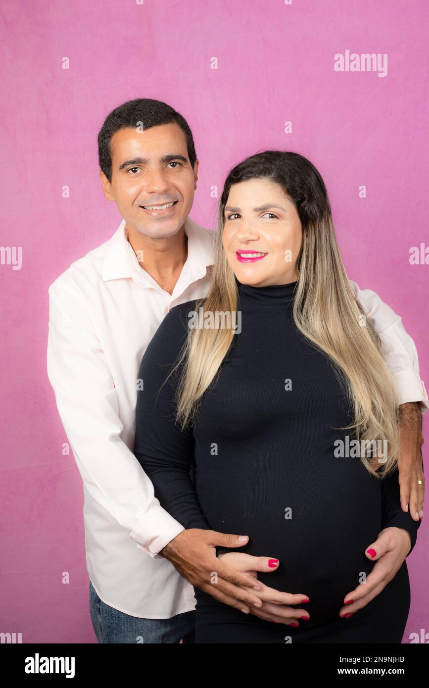 Romantic Couple Of Handsome Husband And Beautiful Pregnant Wife Posing