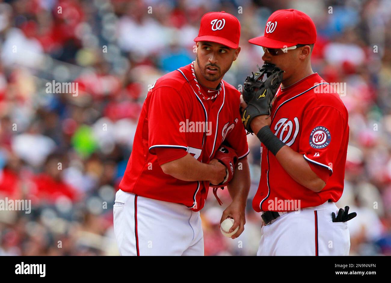 Washington Nationals starting pitcher Gio Gonzalez, left, talks with ...
