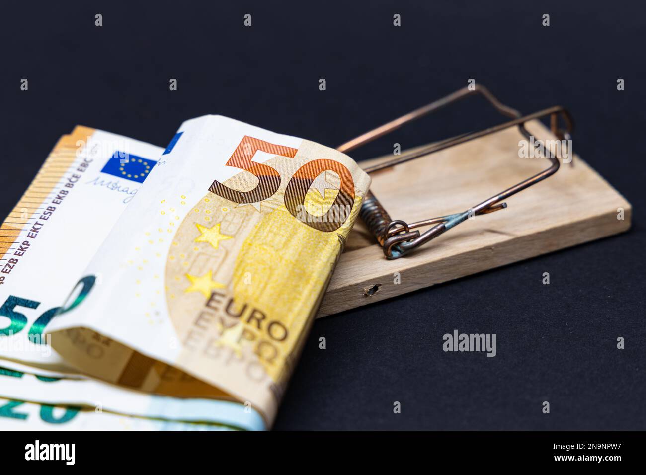 mouse trap with a money bait Stock Photo - Alamy