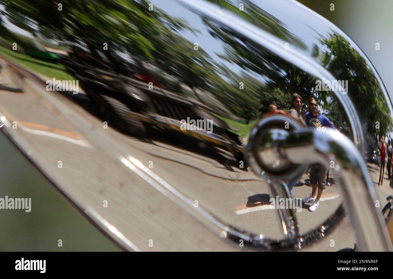 A reflection on Harley-Davidson motorcycle mirror of old ehicle ...