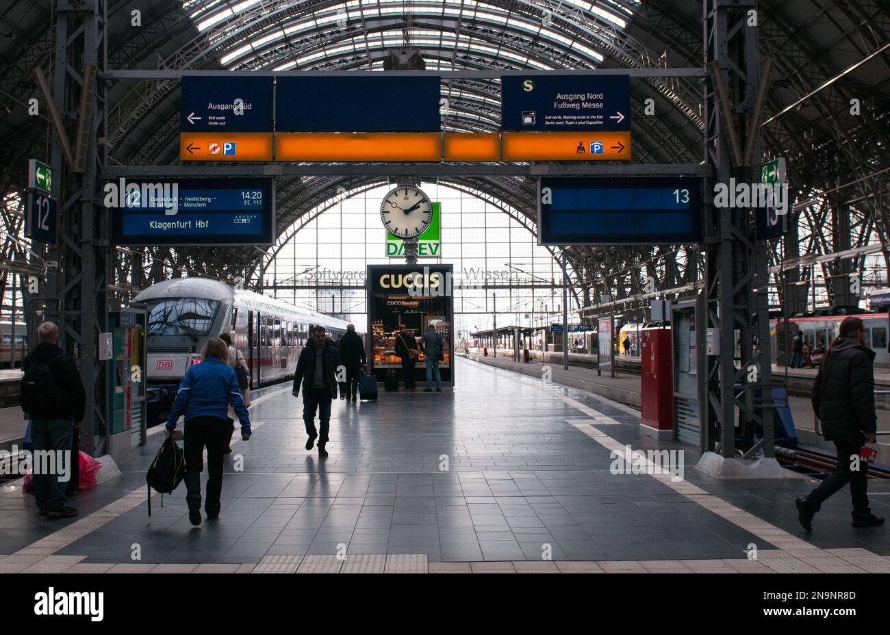 Passengers at the platforms of the main train travel station platform ...
