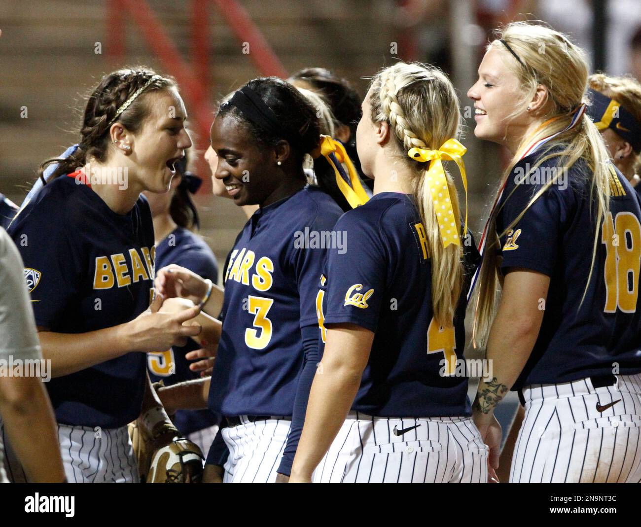California pitcher Jolene Henderson, left center, and Jamia Reid, right ...