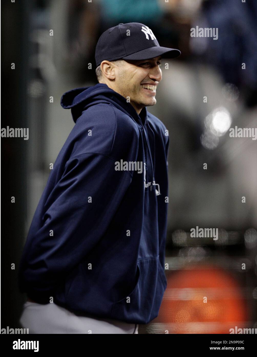 New York Yankees pitcher Andy Pettitte smiles in the dugout against the ...