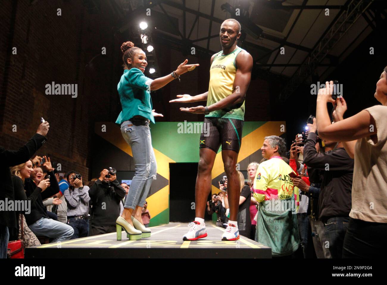 Jamaica's sprinter Usain Bolt, center right, models a Jamaica Olympic ...