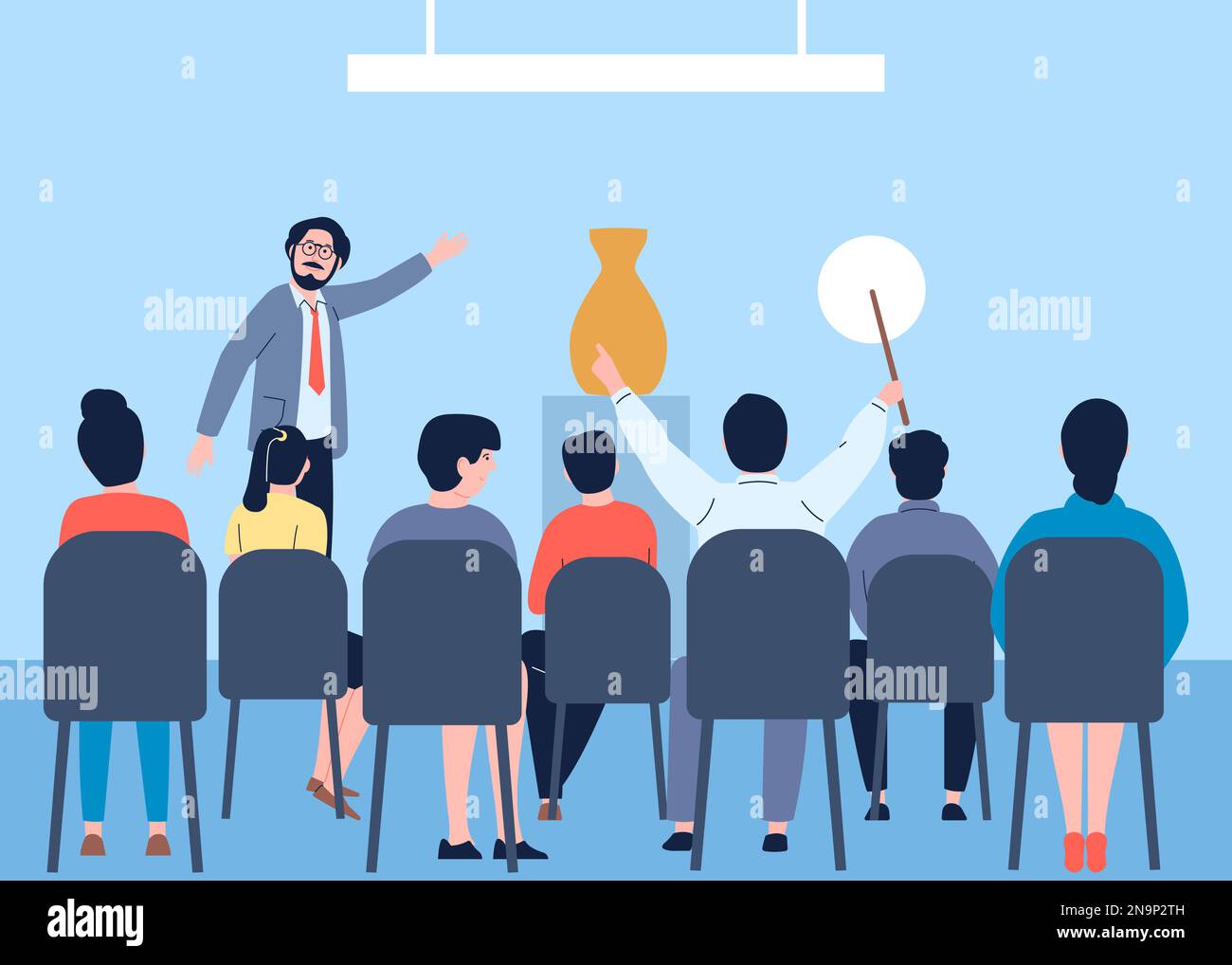 Auction of antiques, man hands up bid plate. People sitting on chairs ...