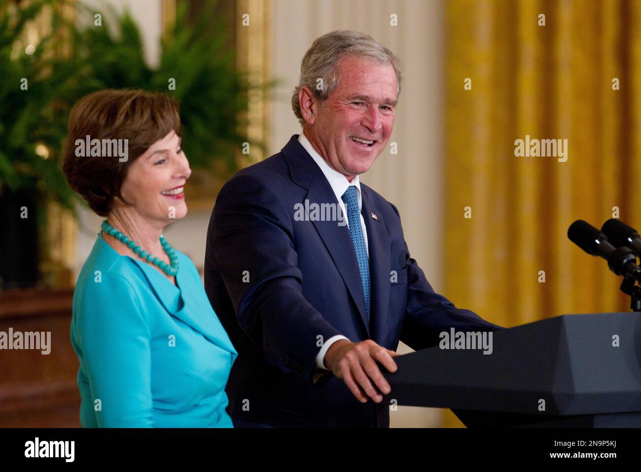 Former President George W. Bush and former first lady Laura Bush stand ...