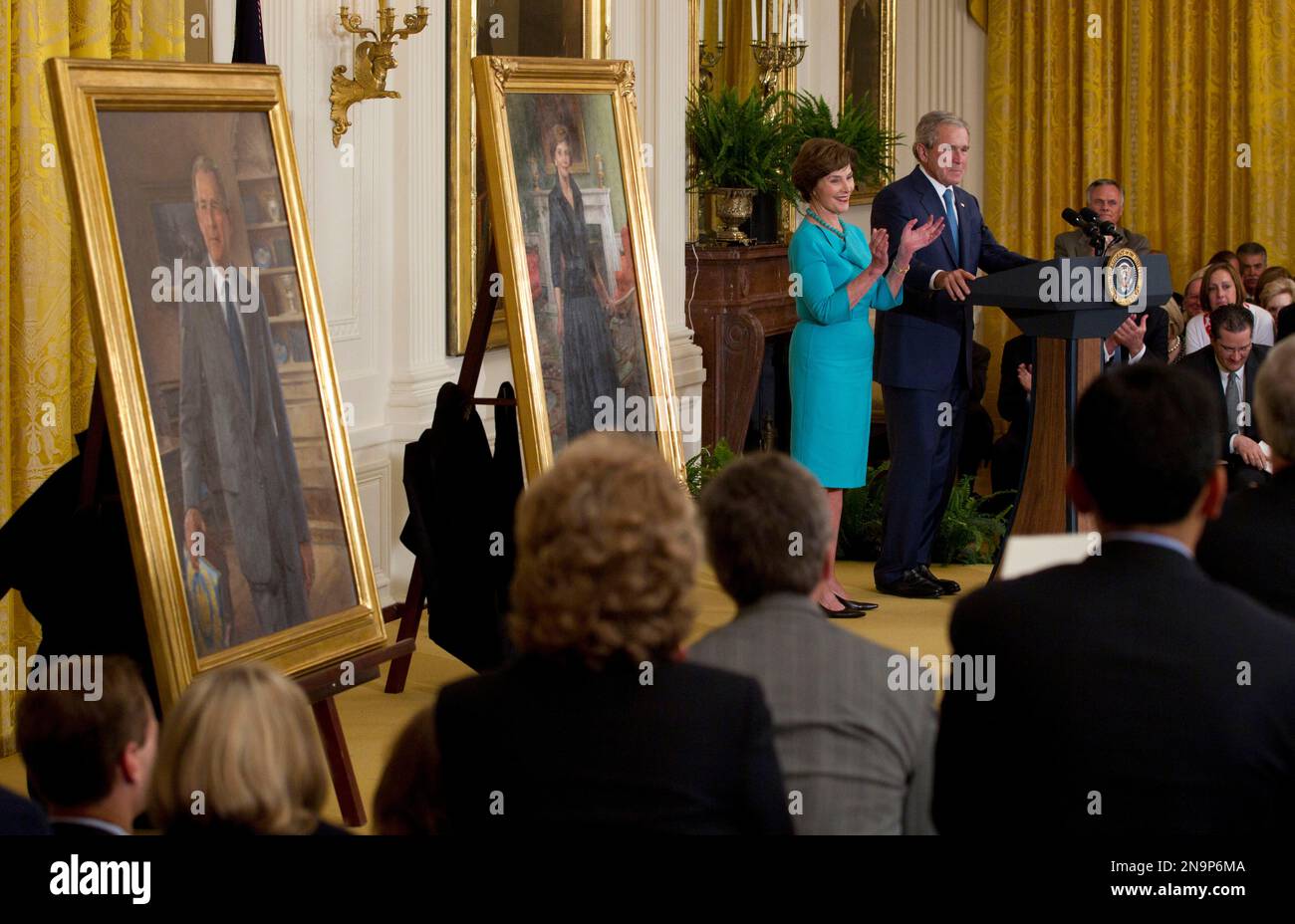 Former President George W. Bush and former first lady Laura Bush stand ...