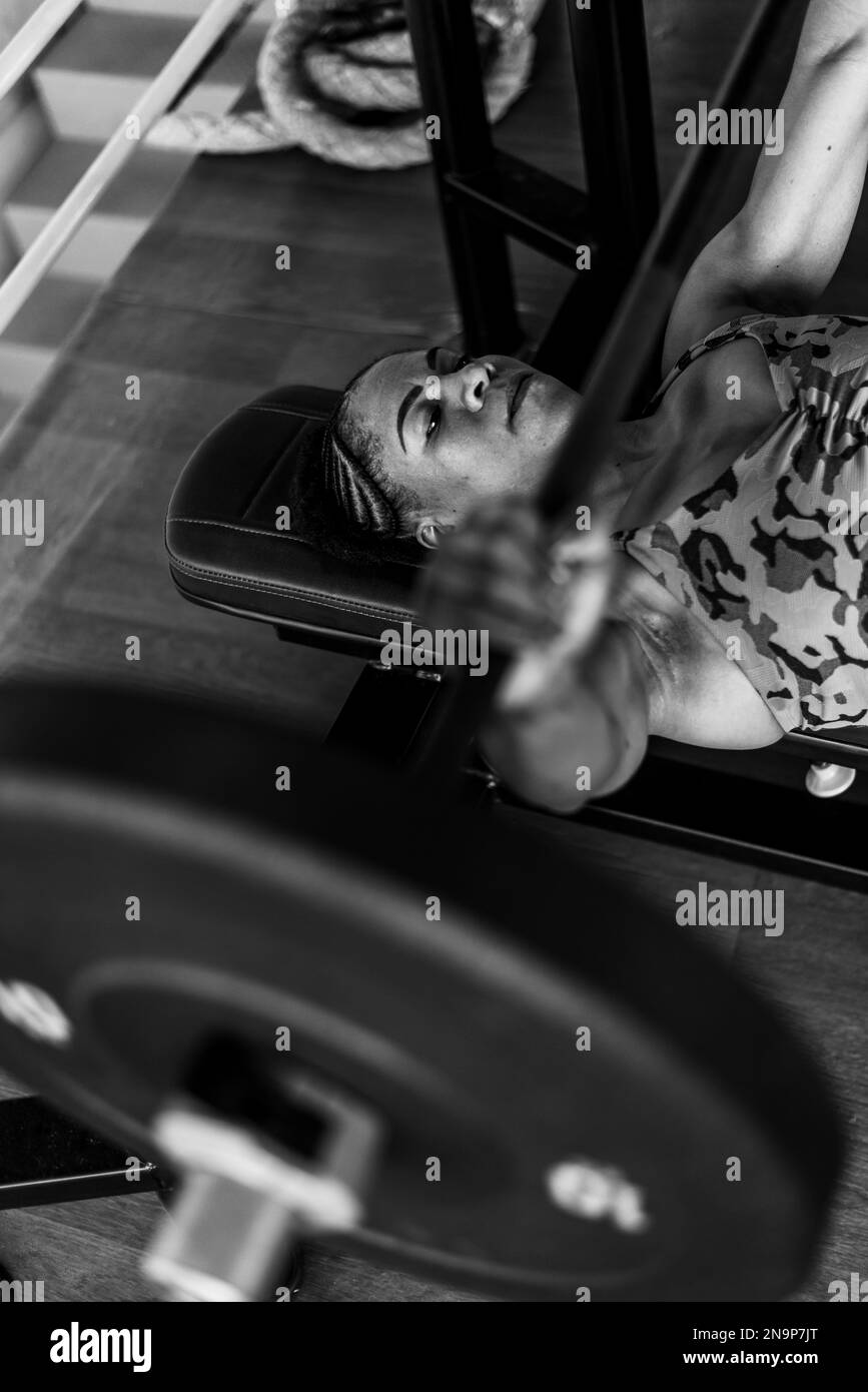 Woman training on the bench press. Strengthening chest, shoulders and ...