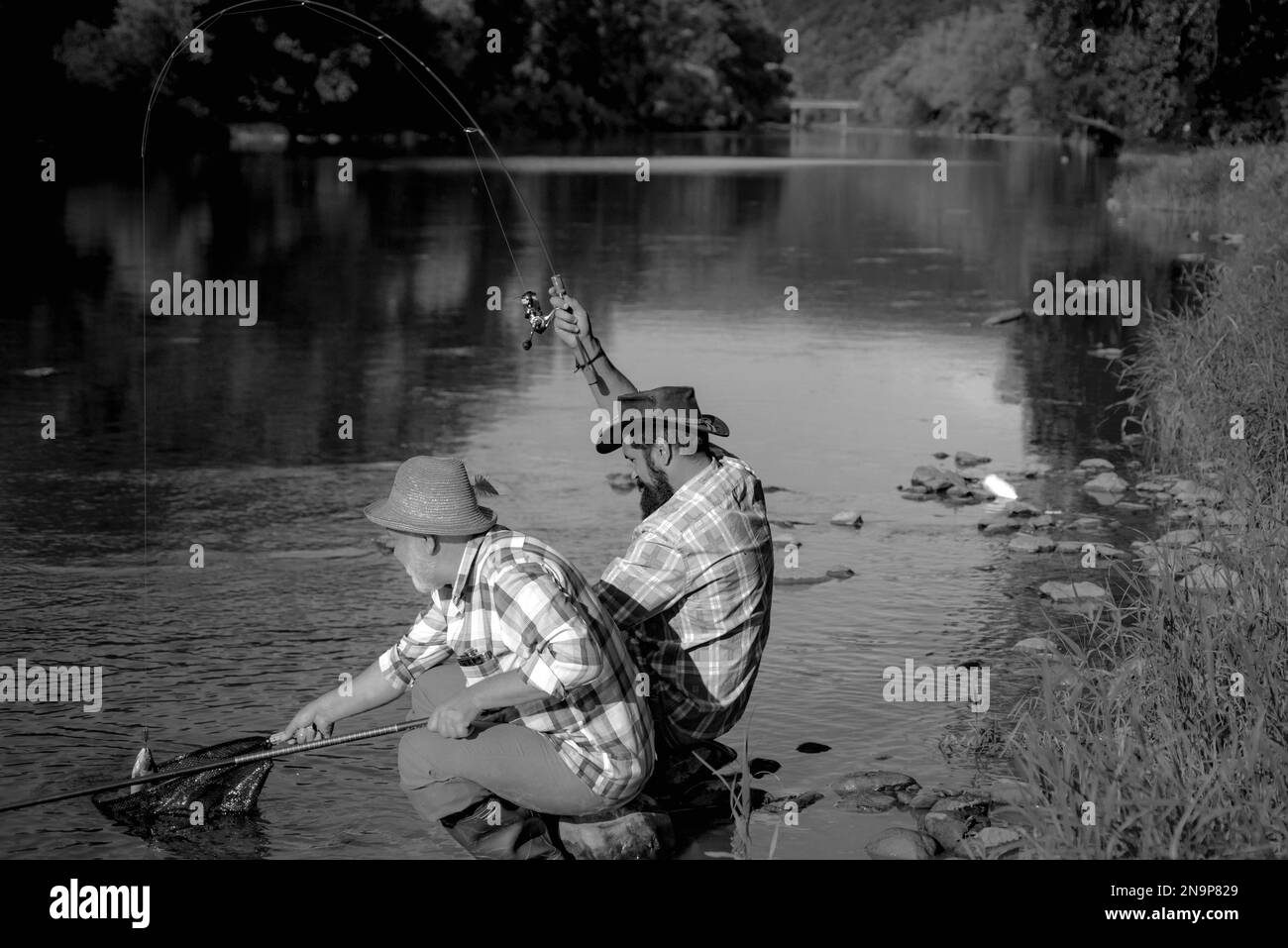 Portrait of cheerful two men fishing. Fly fishing. Perfect weekend ...