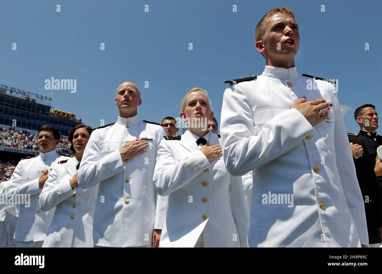 Graduating midshipmen sing "Navy Blue and Gold," the United States ...