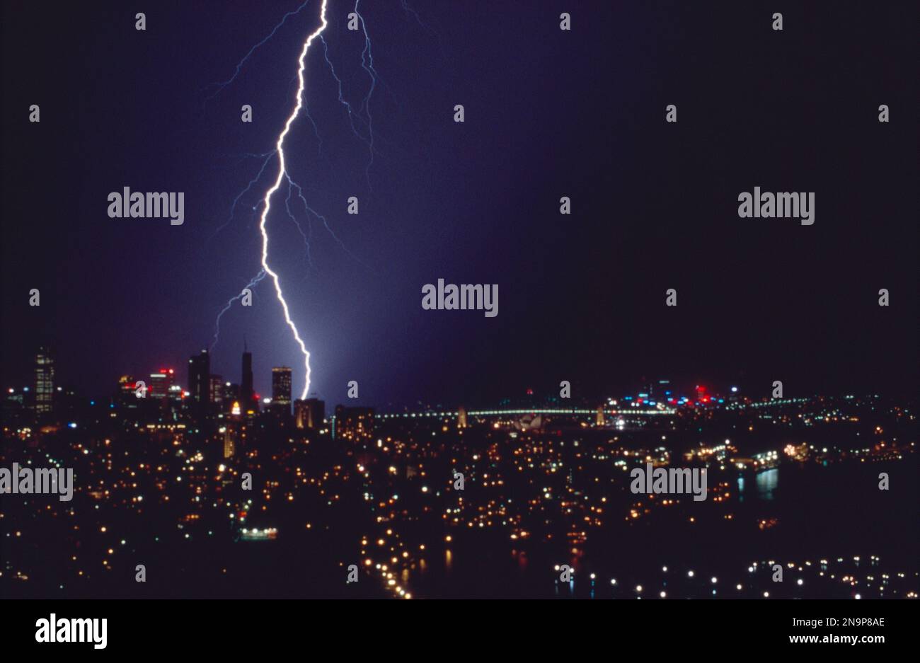 Lightning bolt hitting the ground in a big city Stock Photo - Alamy