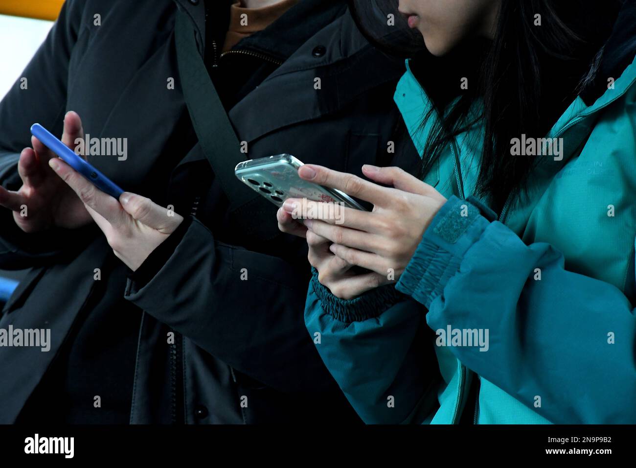 Copenhagen /Denmmark/12 Febraur 2023/ Bus passengers use cellphone ...