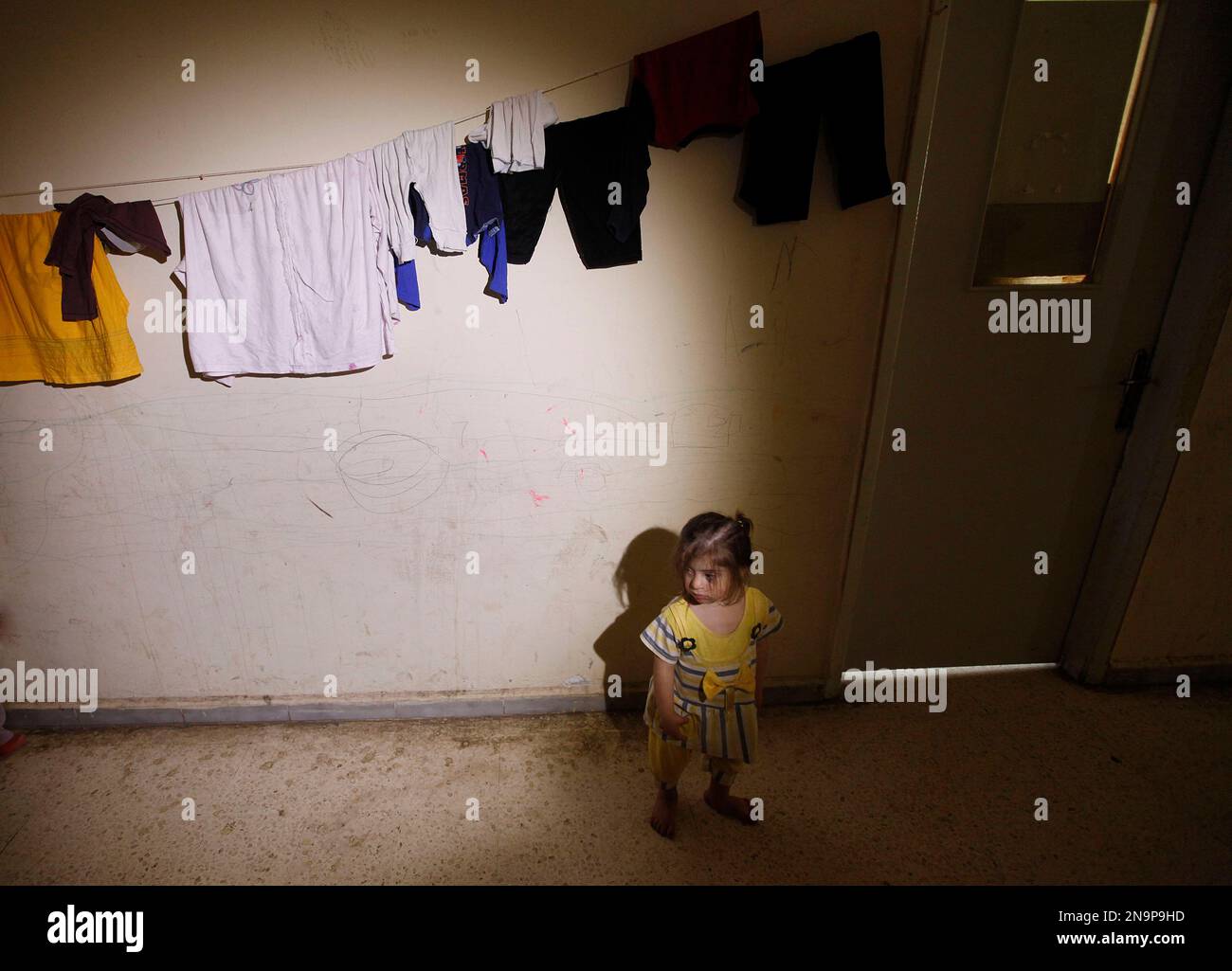 In this Wednesday, May 30, 2012 photo, a Syrian refugee girl, who fled ...