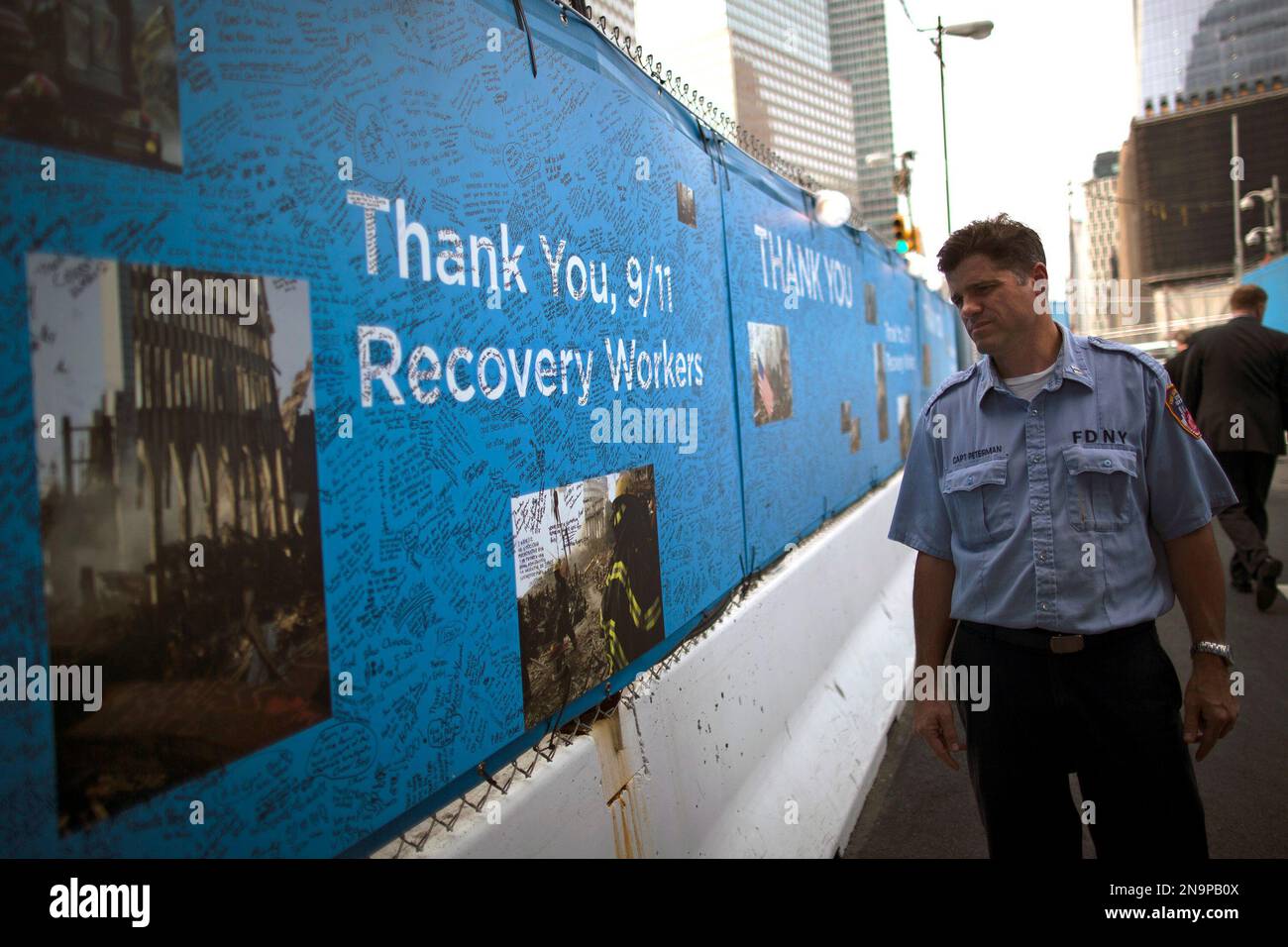 FDNY Capt. Tom Peterman, of Ladder 25, looks at a wall of well-wishes ...