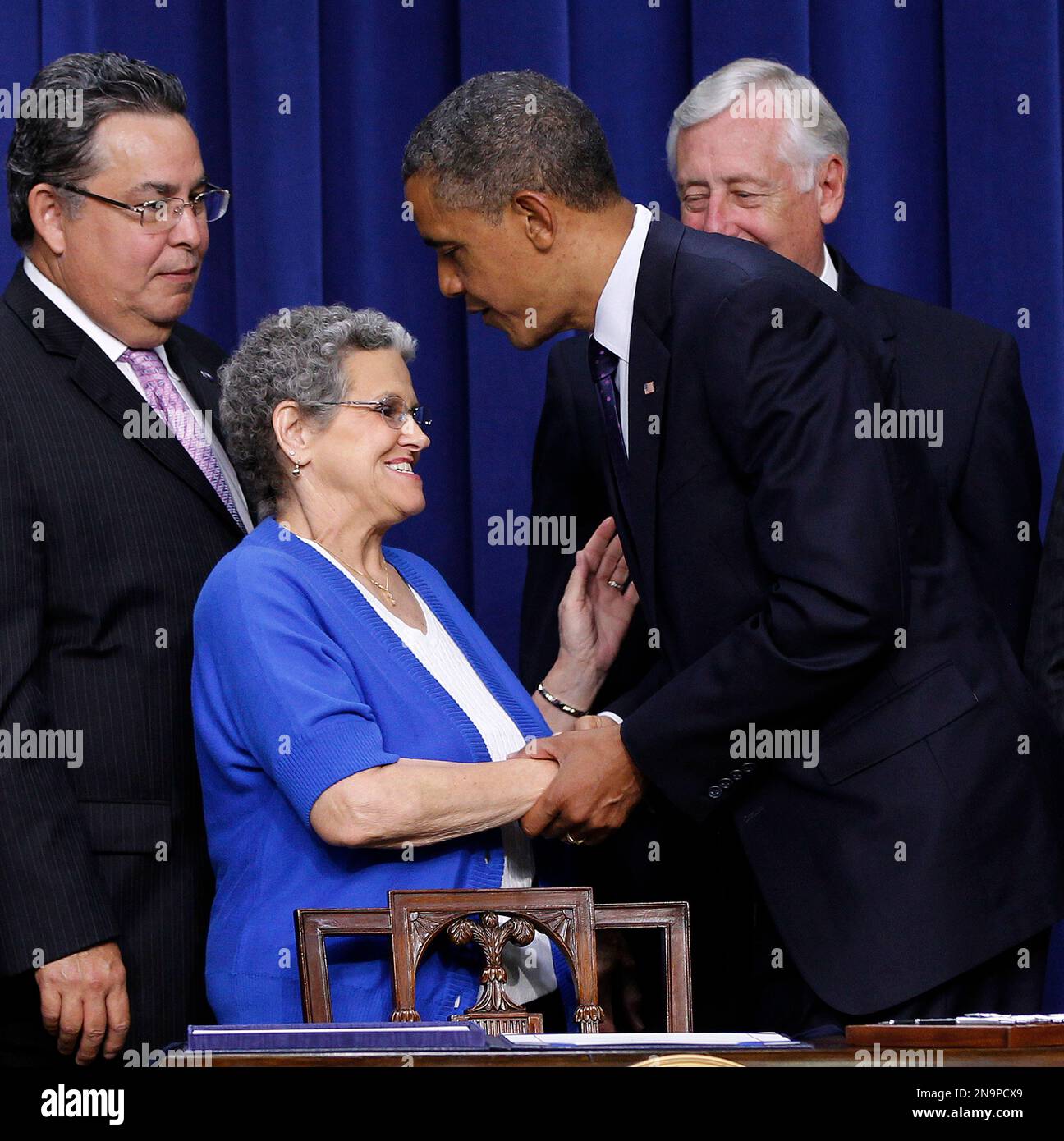 President Barack Obama greets Sharon O'Hara, left, Executive Office ...