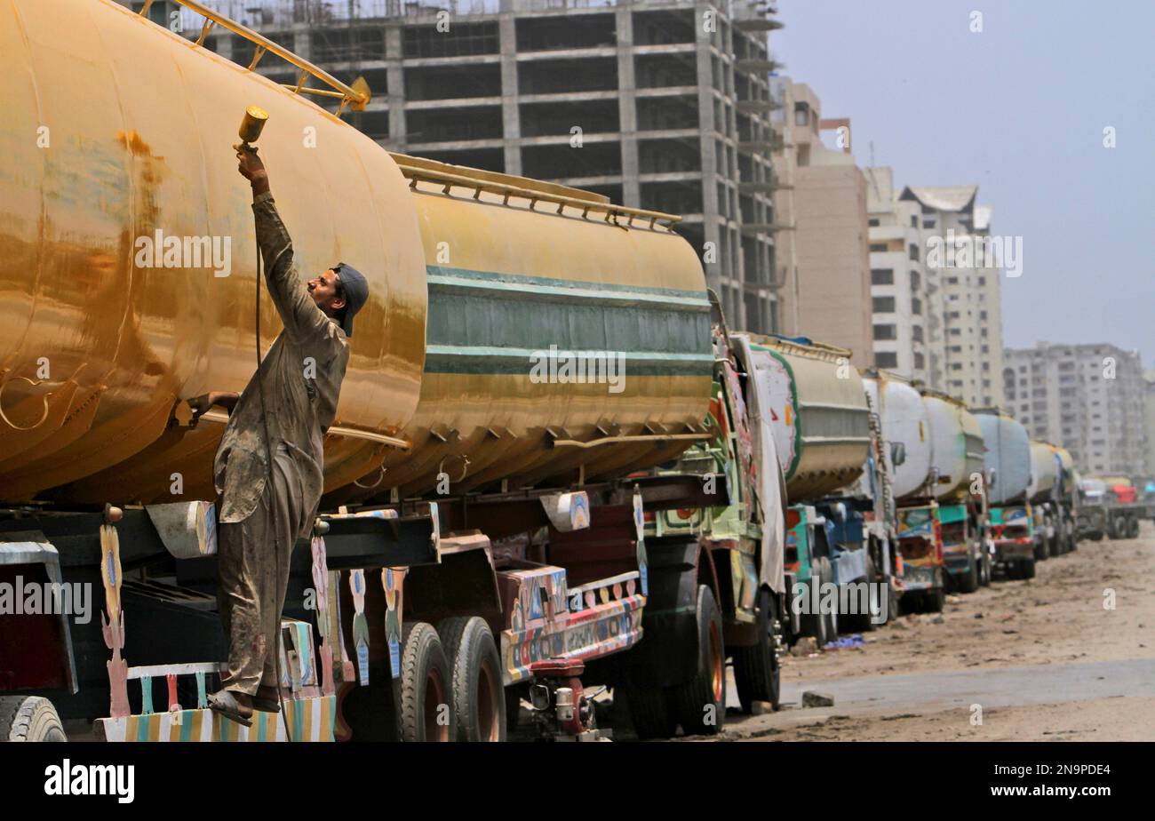 A Pakistani man paints an oil tankers, which was used to transport NATO ...