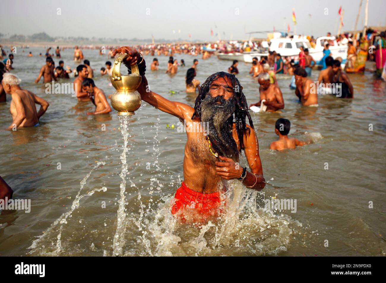 Hindu devotees take holy dip at the Sangam, the confluence of the ...