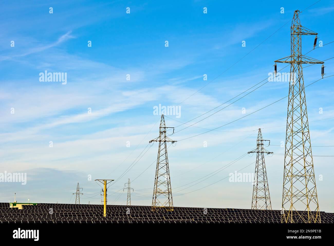 Photovoltaic farm and electric lines Stock Photo - Alamy