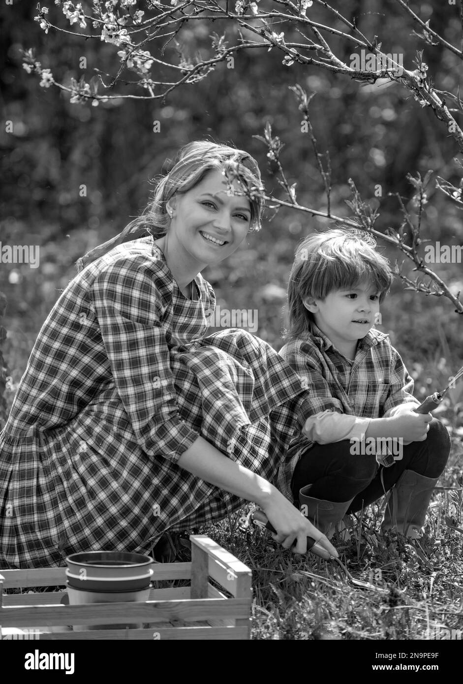 Mother and son farmers in the farm with countryside background. Eco ...